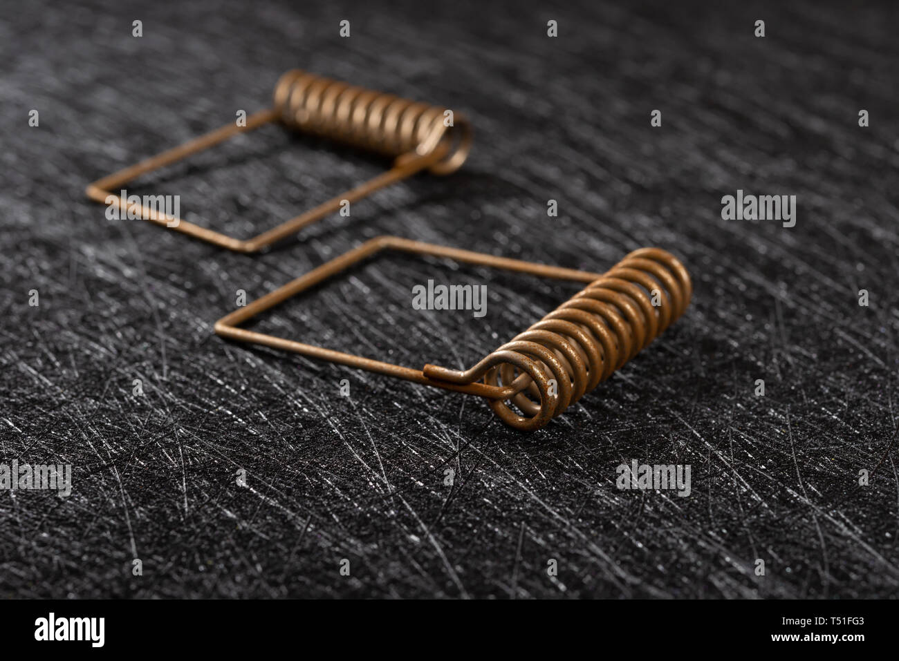 side view two pieces rusty springs on dark background Stock Photo - Alamy
