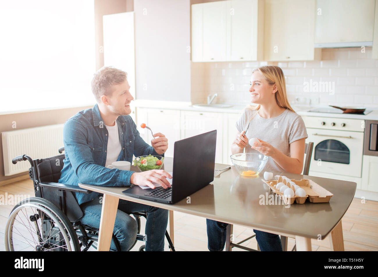 Happy cheerful young student with disability and inclusiveness eating ...