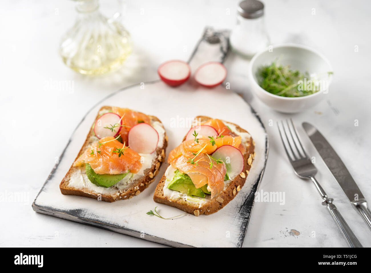 Two toasts with avocado, radish and salmon. Healthy eating Stock Photo ...