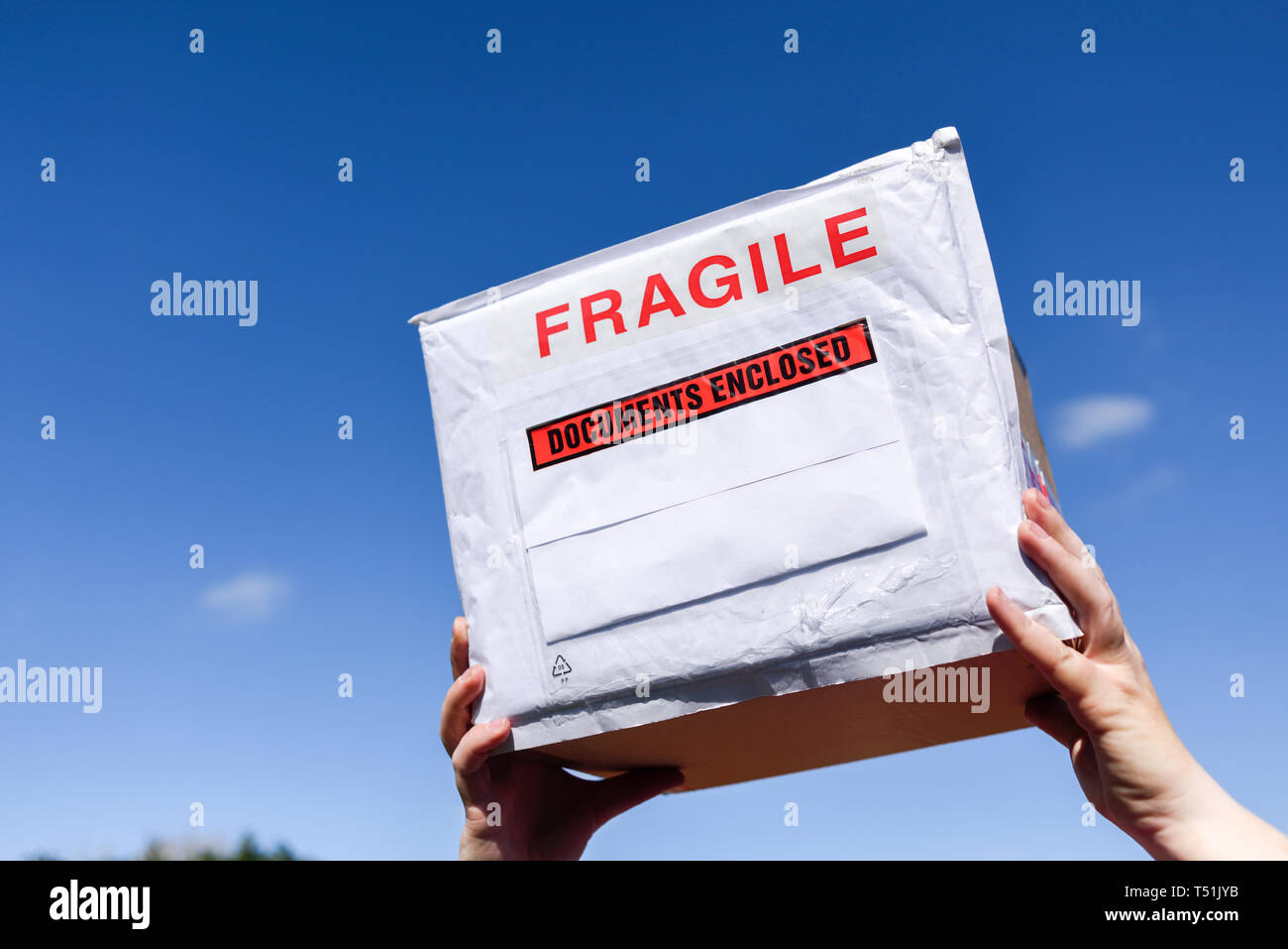 Fragile parcel against a blue sky Stock Photo - Alamy