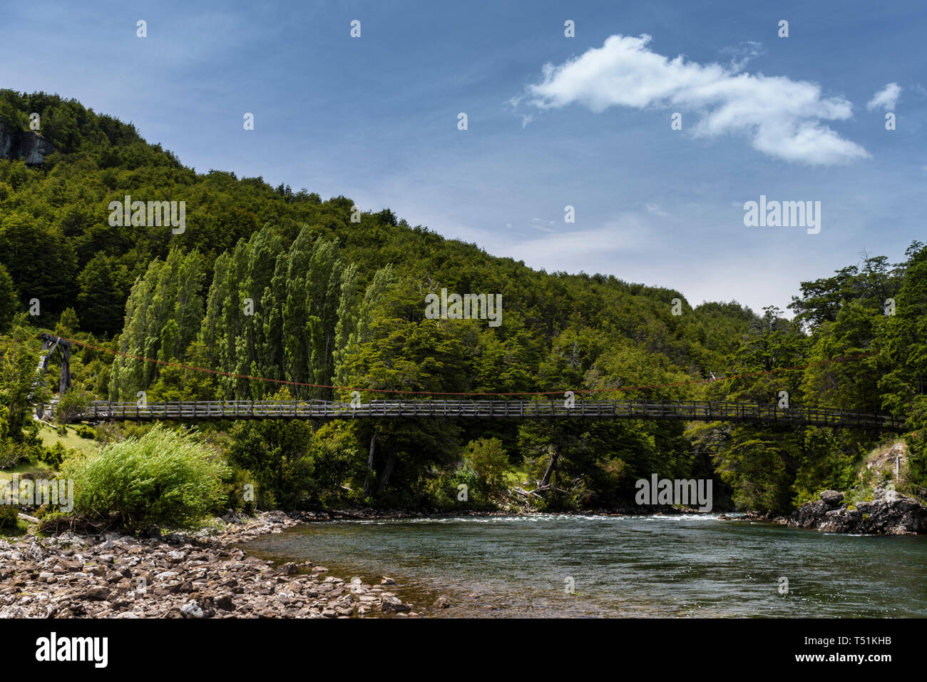 Wooden suspension bridge against andes mountains, Futaleufú, Chile ...