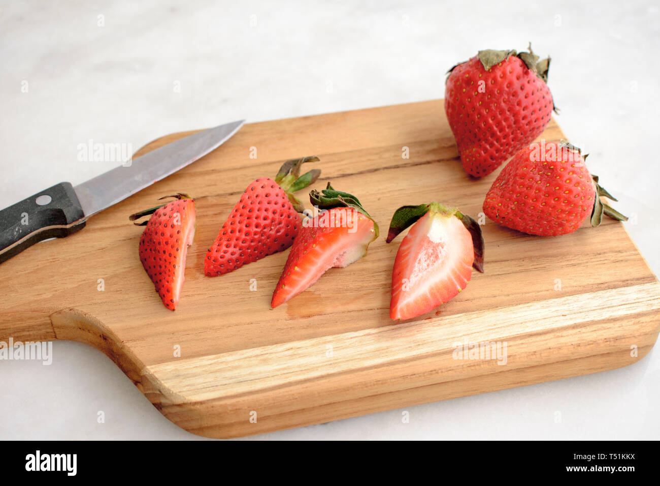 Slicing Strawberries on a Cutting Board Stock Photo - Alamy