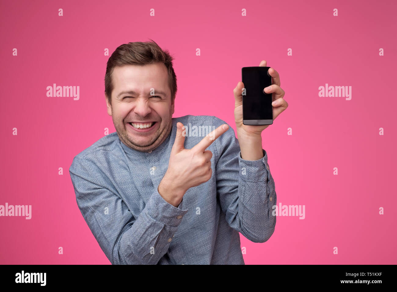 Smiling man pointing screen hi-res stock photography and images - Alamy