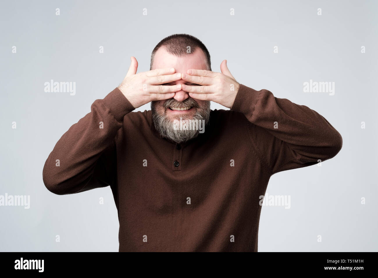 European mature man covering his face by hands Stock Photo - Alamy