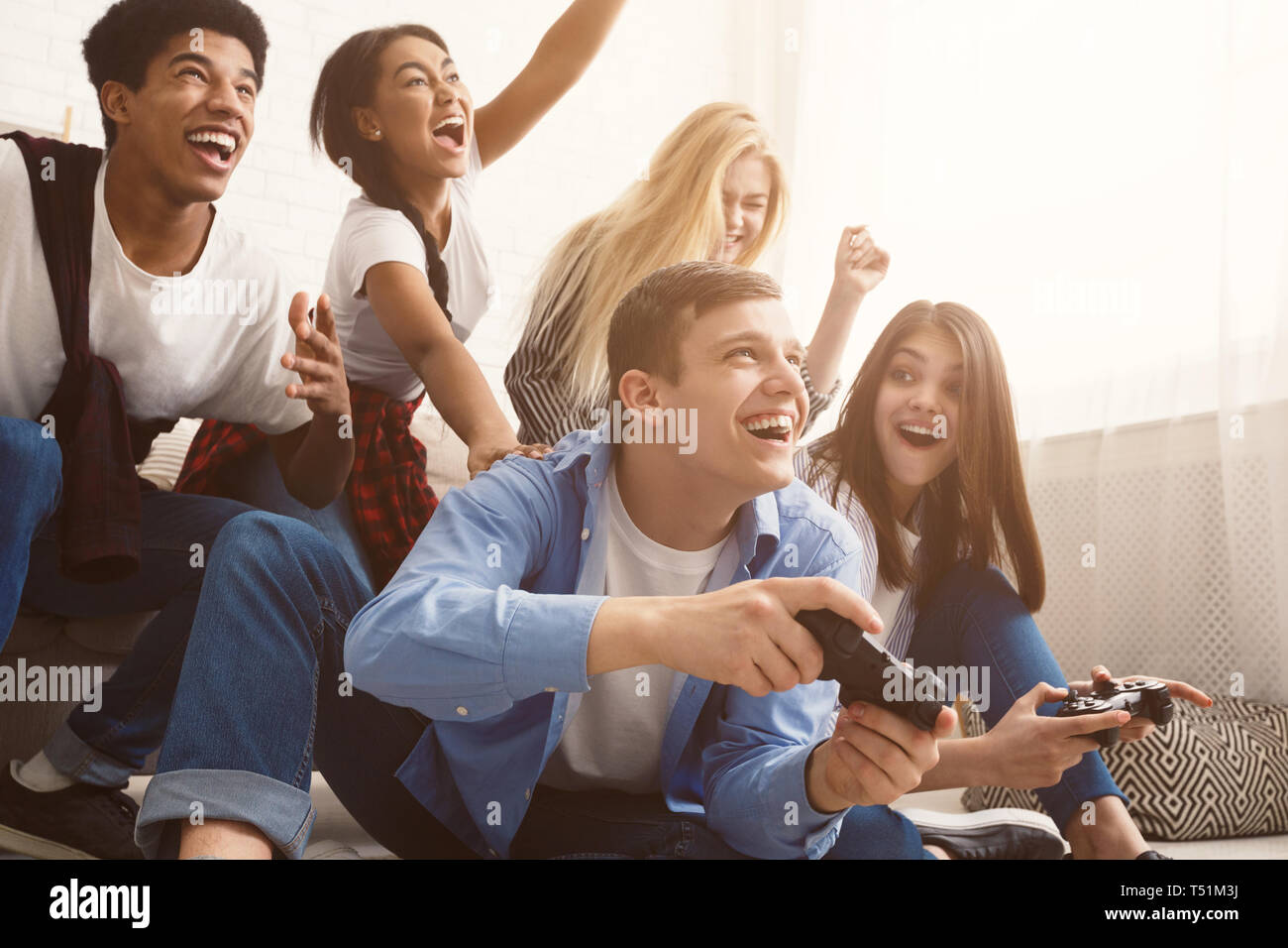 Teenagers having fun, playing video games online Stock Photo - Alamy