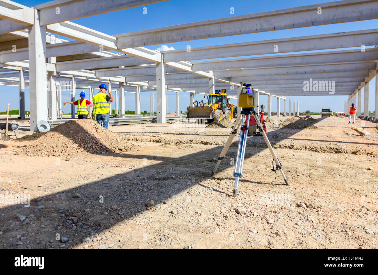 Total center device on tripod with laser for leveling other devices to ...