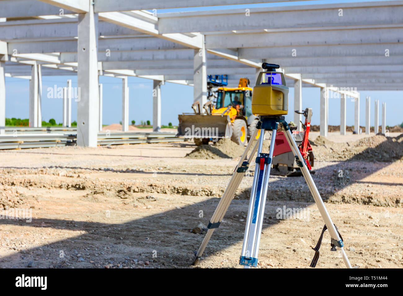Total center device on tripod with laser for leveling other devices to ...