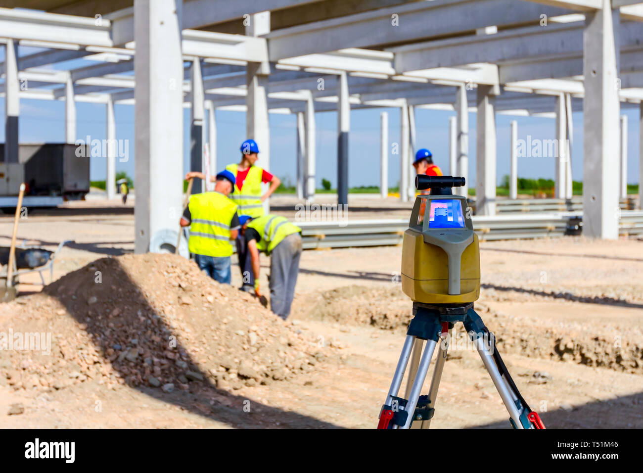 Total center device on tripod with laser for leveling other devices to ...