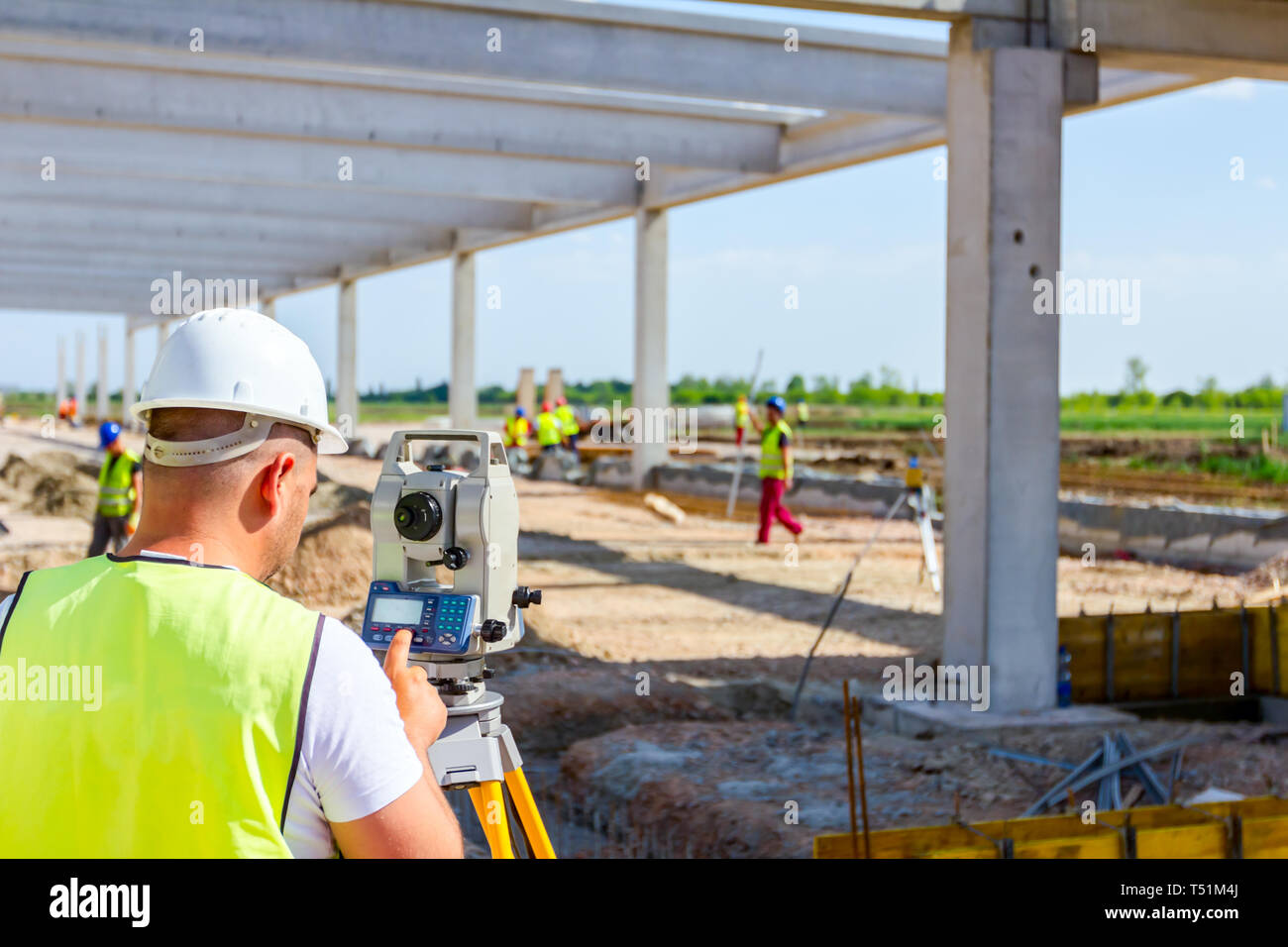 Surveyor engineer is measuring level on construction site. Surveyors ...