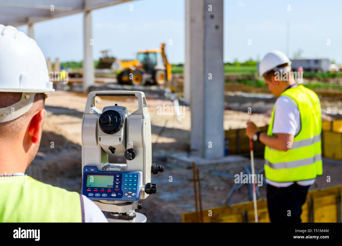 Surveyor engineer is measuring level on construction site. Surveyors ...