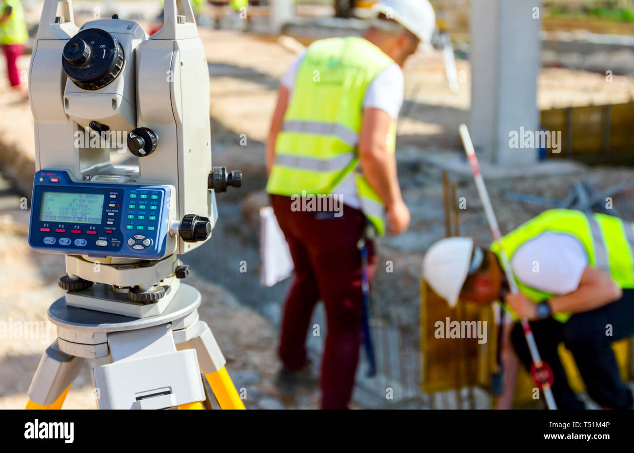 Surveyor engineer is measuring level on construction site. Surveyors ...