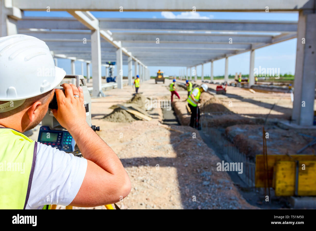 Surveyor engineer is measuring level on construction site. Surveyors ...