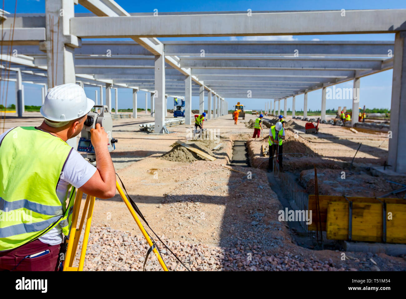 Surveyor engineer is measuring level on construction site. Surveyors ...