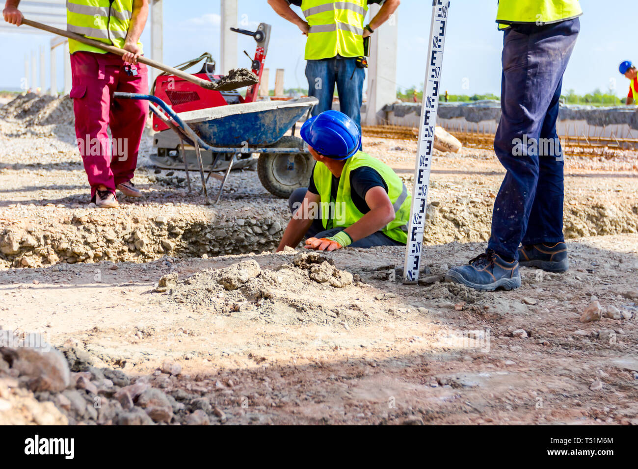 Construction worker is using tool to realign, correct measure or level ...