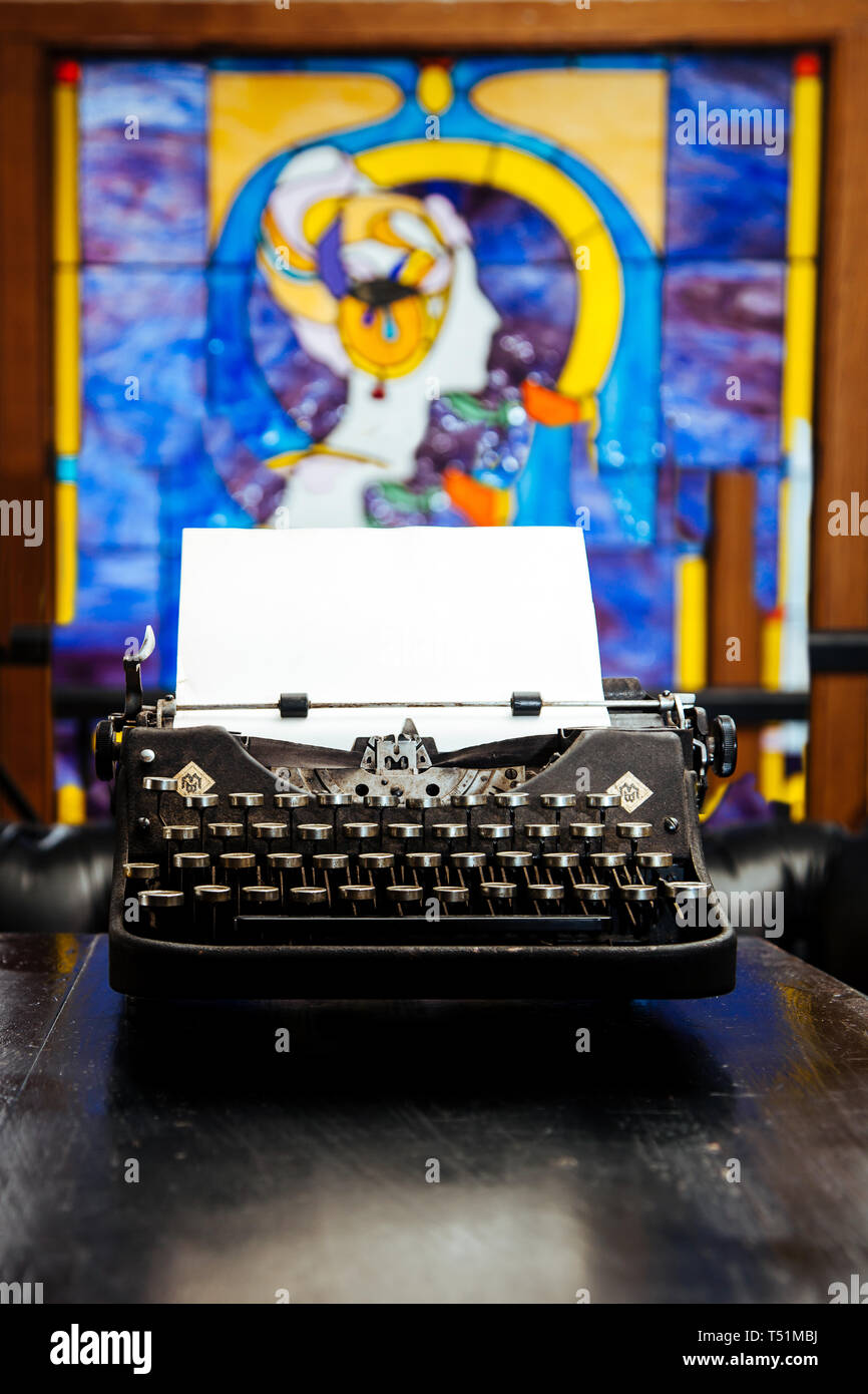 Old antique manual typewriter on the table of the writer in front of ...