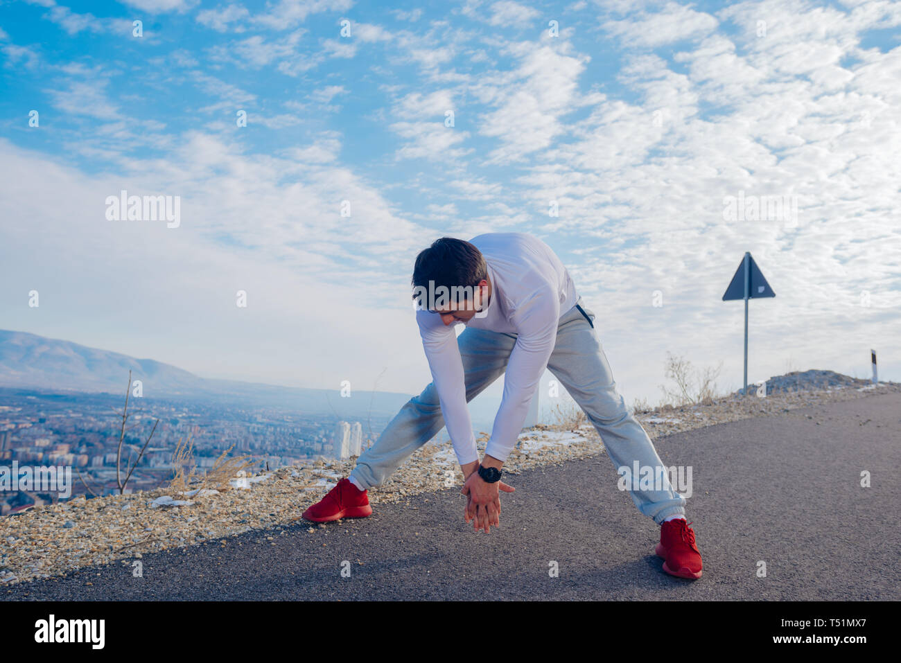 Fit male stretching and performing his morning routines while wearing a ...