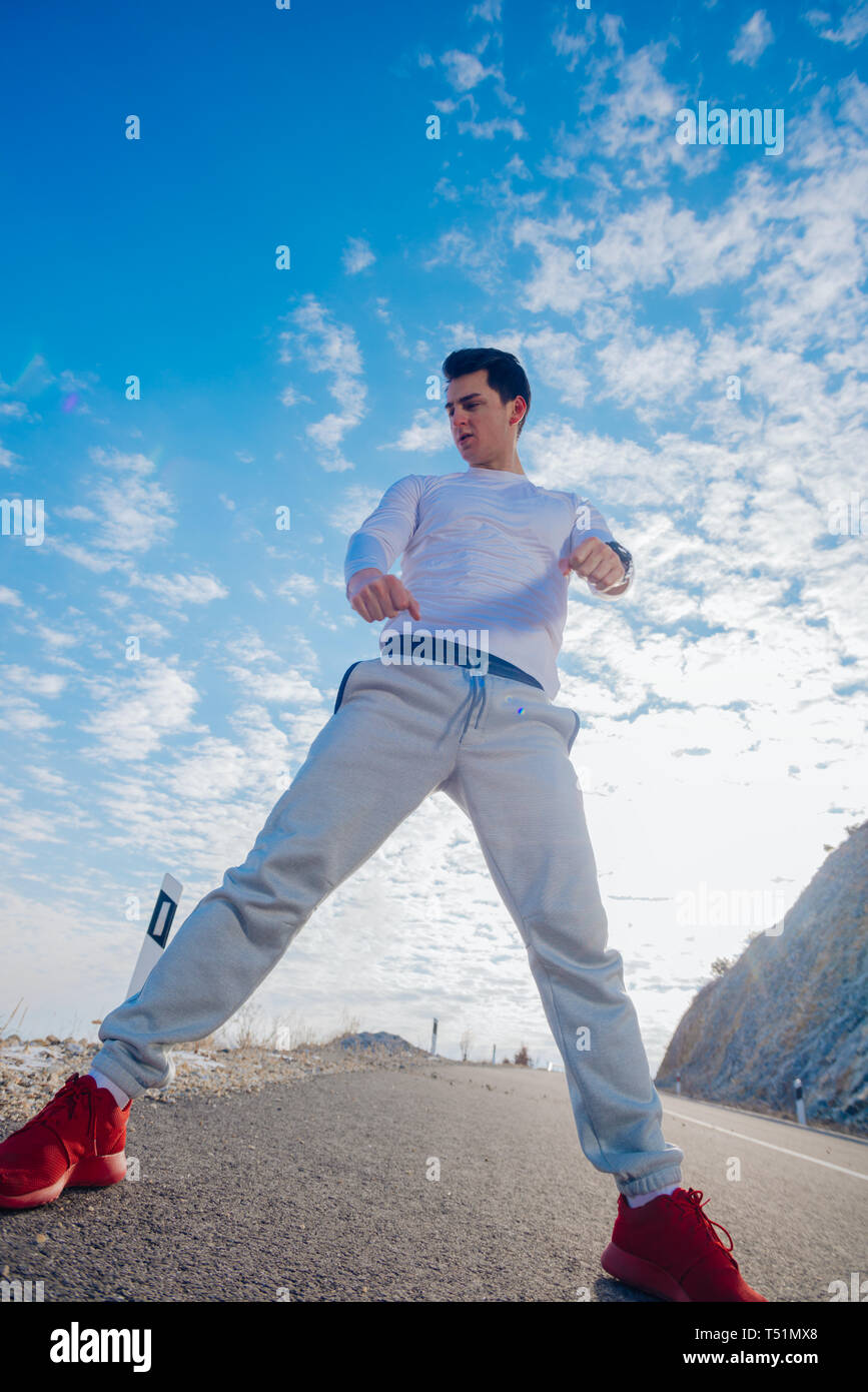 Fit male stretching and performing his morning routines while wearing a ...