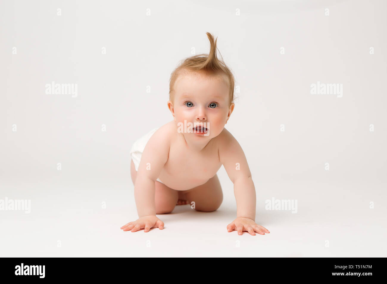 Cute little baby in diapers crawling on white background,bright picture ...