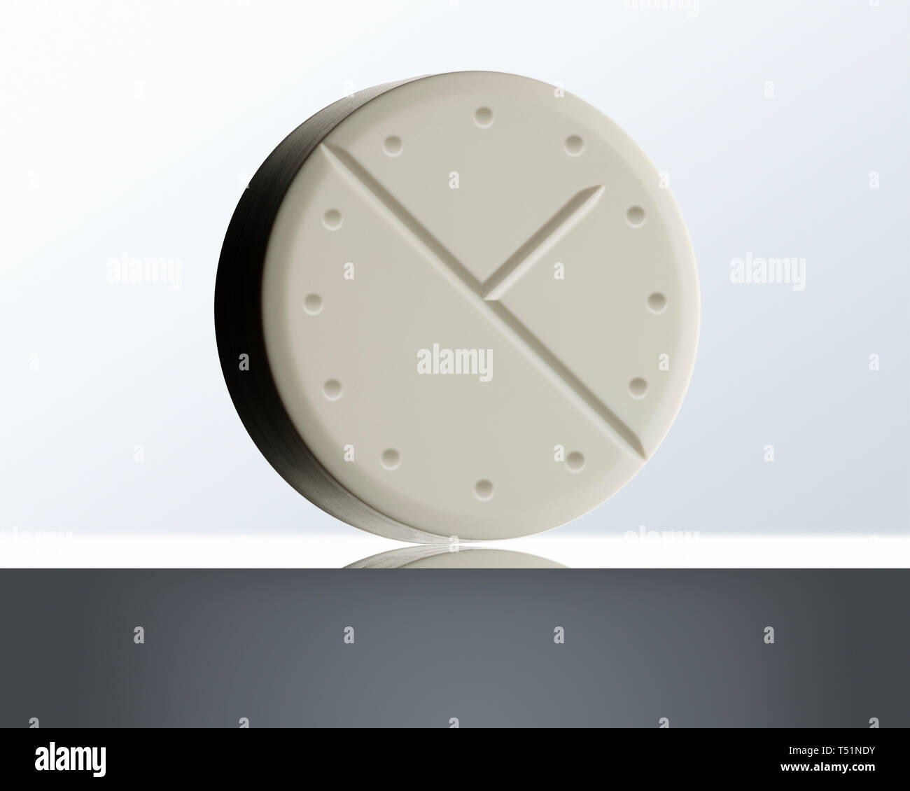 Pill with a clock carved in it Stock Photo - Alamy