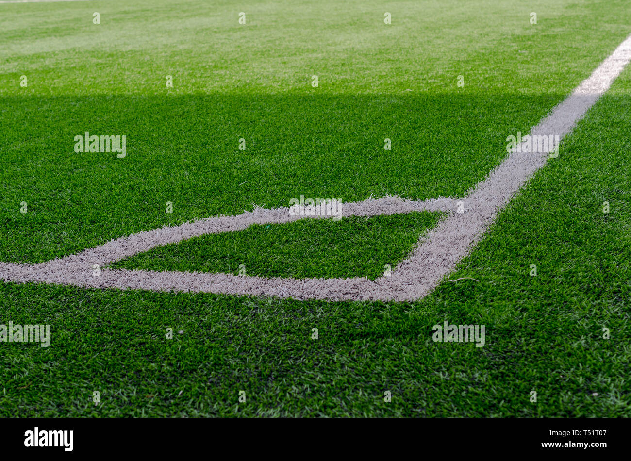 White marking corner on a bright green football field Stock Photo - Alamy