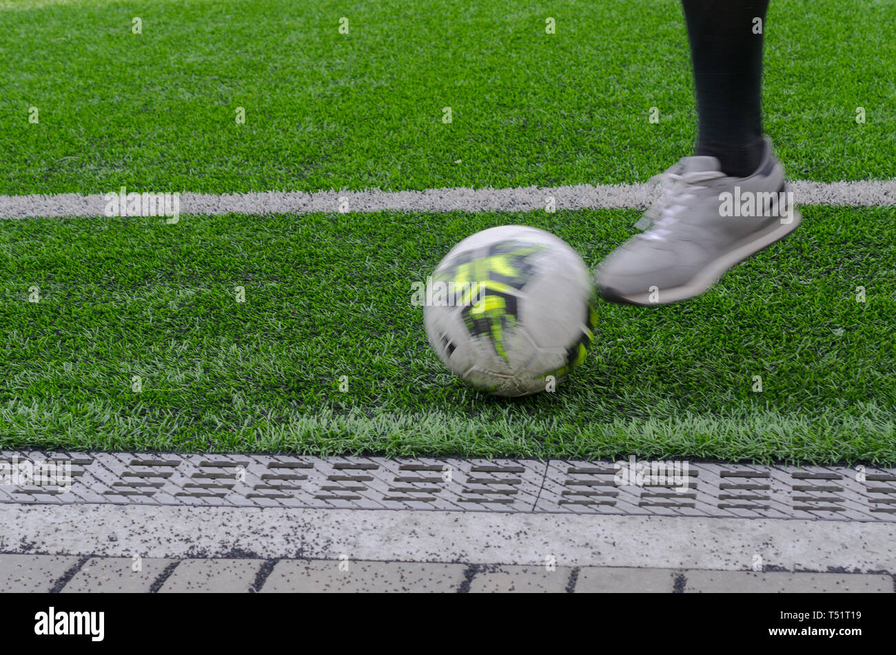 Foot football player hits the ball from the edge of the field Stock ...
