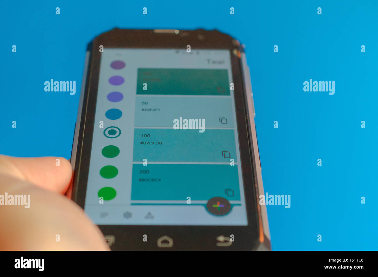 Electronic color palettes between smartphone and blue background Stock ...