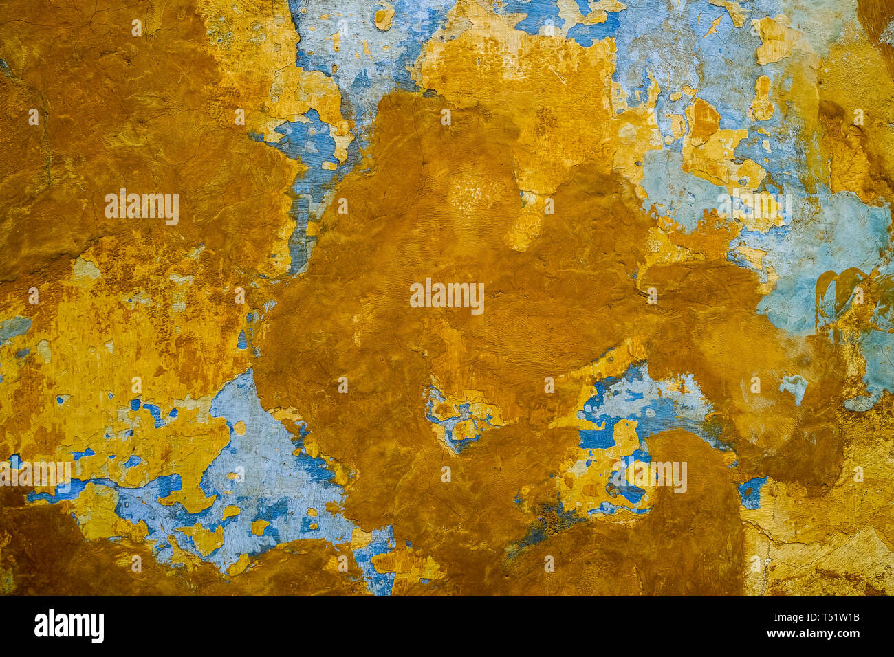 Colorful structure of old shabby wall painted with blue, yellow and ...