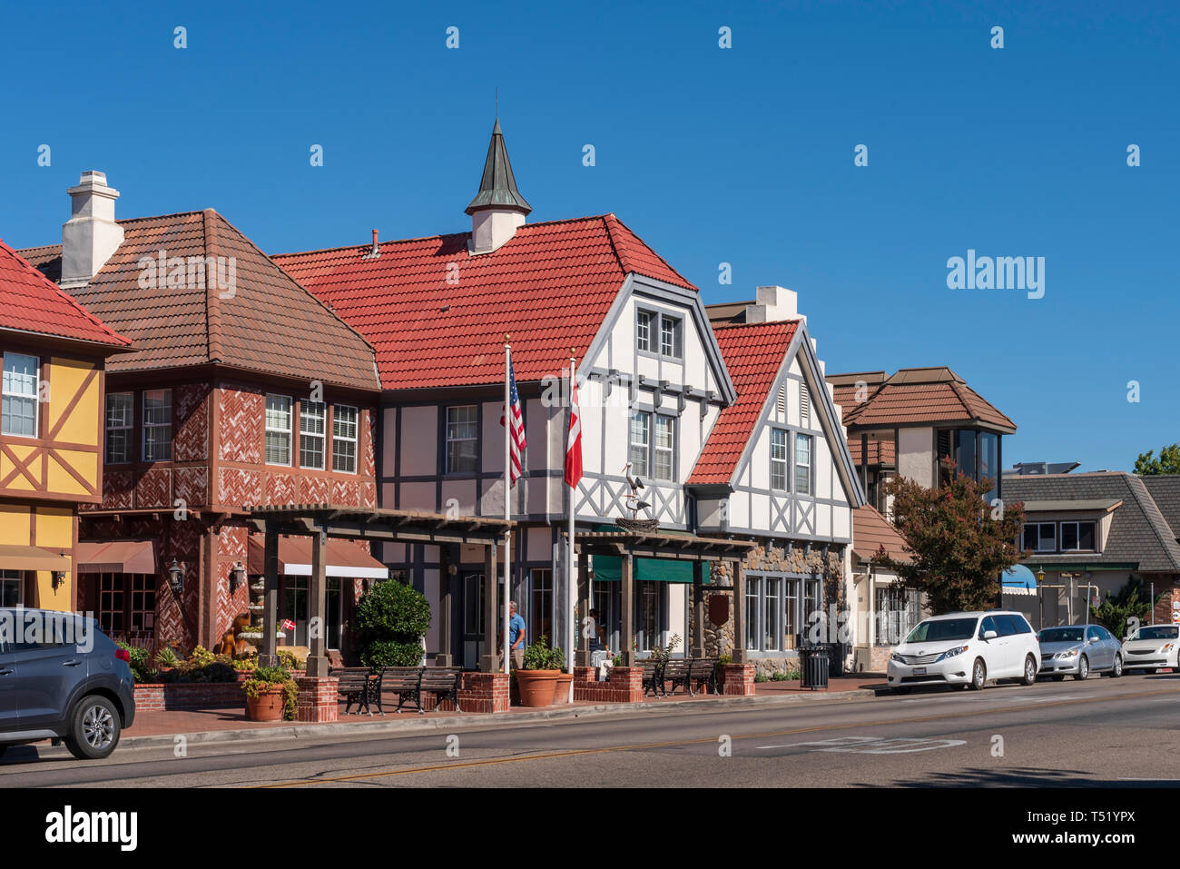 Small town city street with unique building architecture and red tile ...