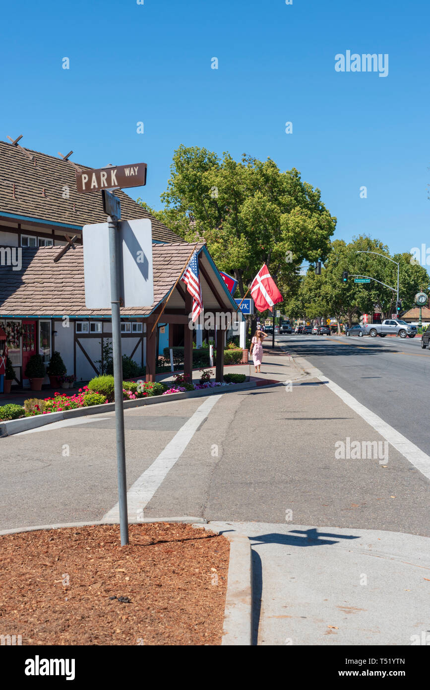 Small town street with person entering crosswalk Stock Photo - Alamy
