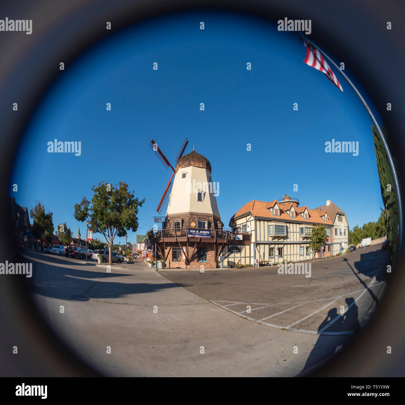 Small town street with a windmill and store under windmill. Two story ...