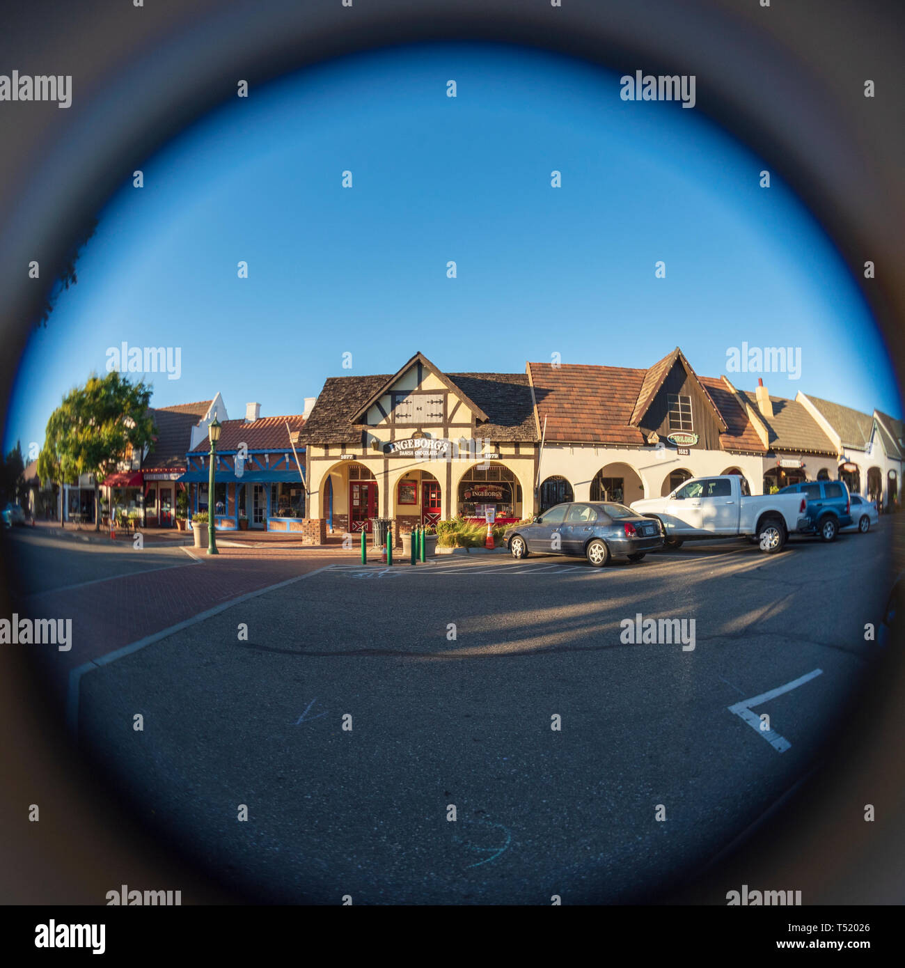Small town street with parked cars and businesses. Wide angle view ...