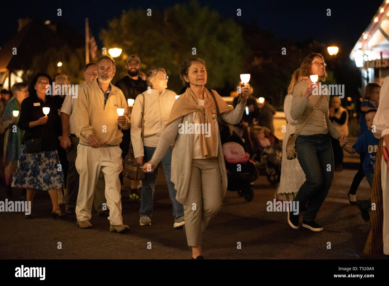 People walking in parade holding lighted candles Stock Photo - Alamy