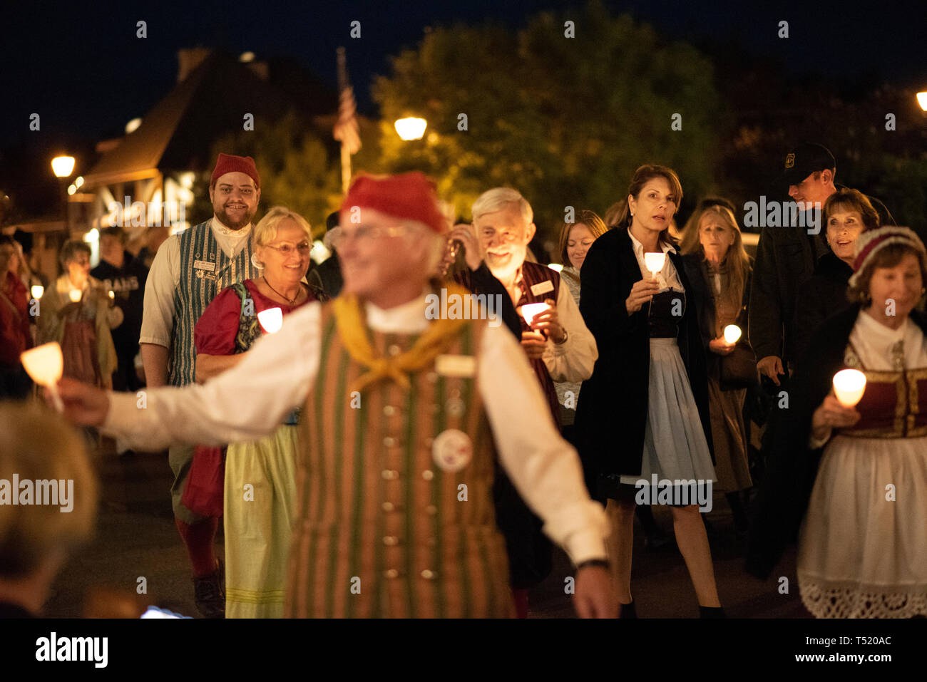 PWomwn in holding candle in parade Stock Photo - Alamy