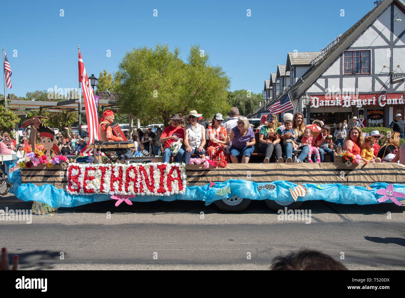 Float with people in street parade Stock Photo - Alamy
