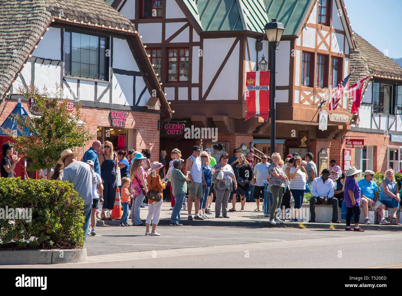 People lining up on sidewalks and curbs for the start of a parade Stock ...