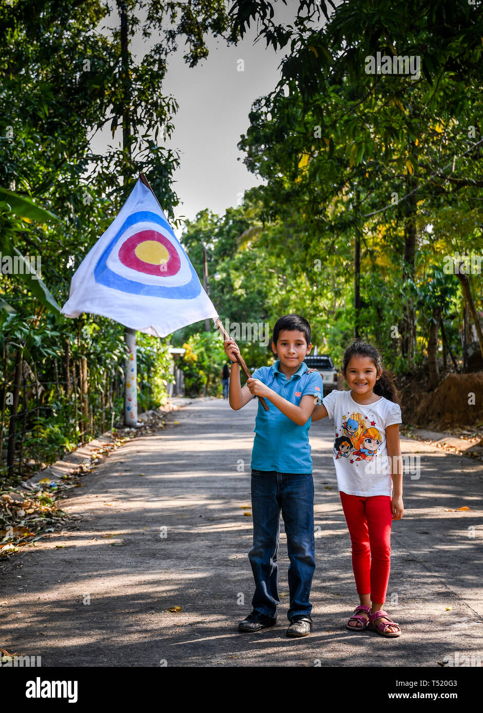 two siblings waving flag in Guatemalan street Stock Photo - Alamy