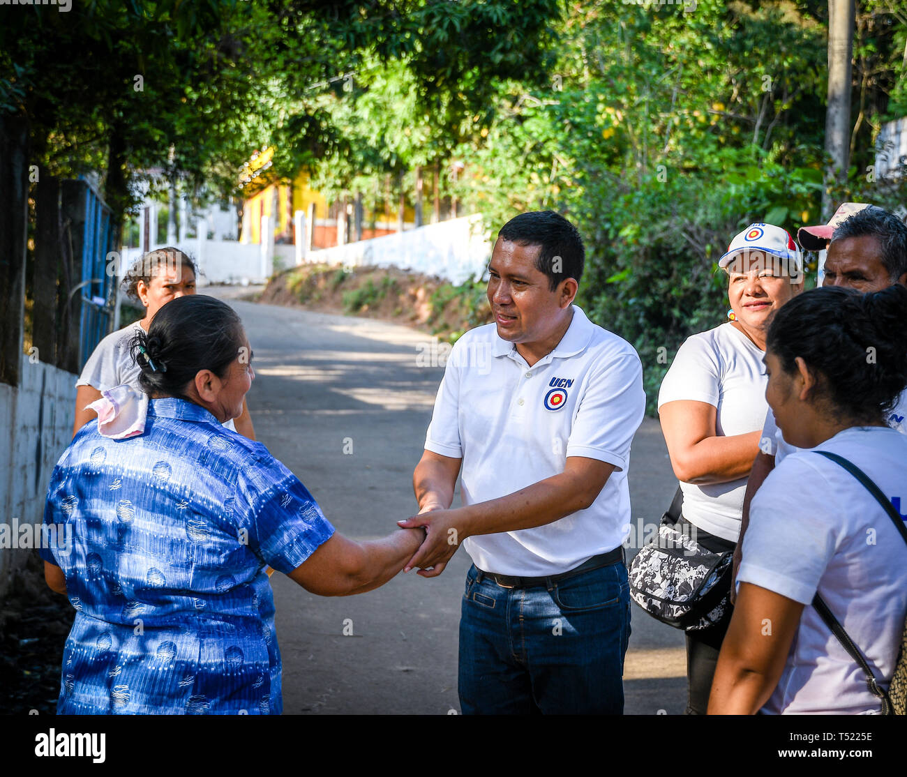 Guatemalan people shaking hands in rural village Stock Photo - Alamy