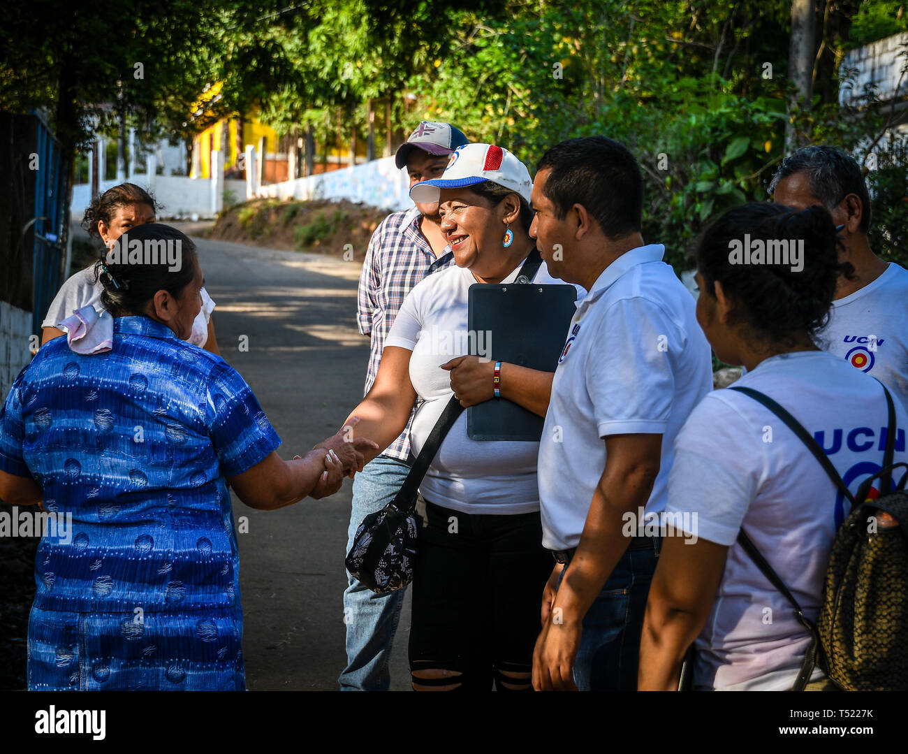 Guatemalan people shaking hands in rural village Stock Photo - Alamy