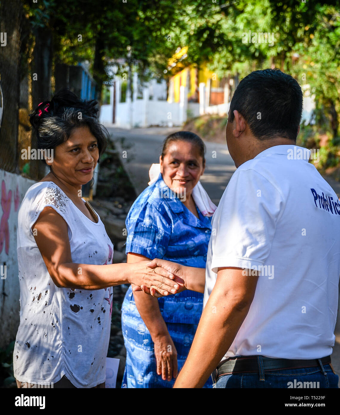 Guatemalan people shaking hands in rural village Stock Photo - Alamy