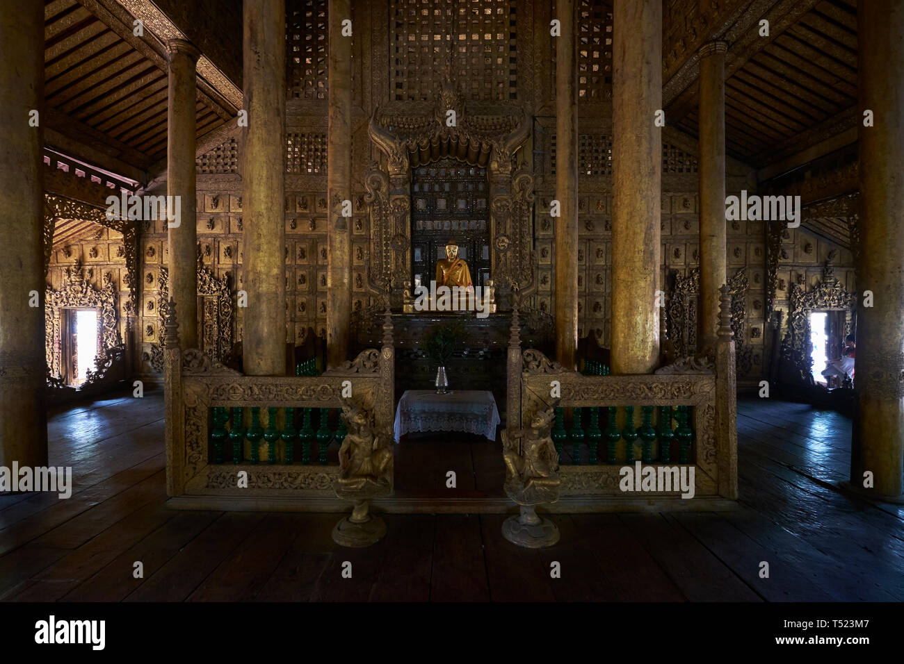 Altar in the gold interior of the old wooden teak constructed ...
