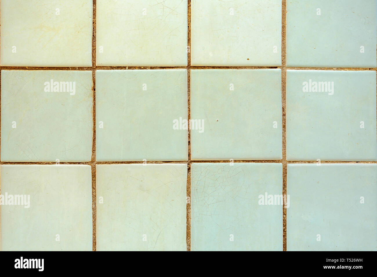 Yellowed old ceramic wall tiles Stock Photo - Alamy