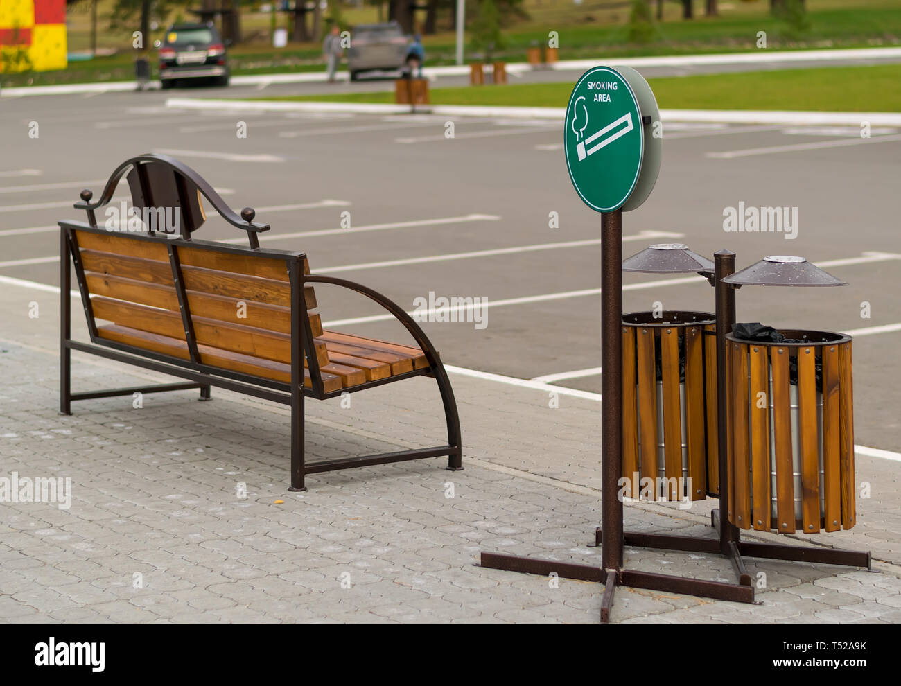 Sign, symbol, Smoking area, with benches in the Parking area for cars ...