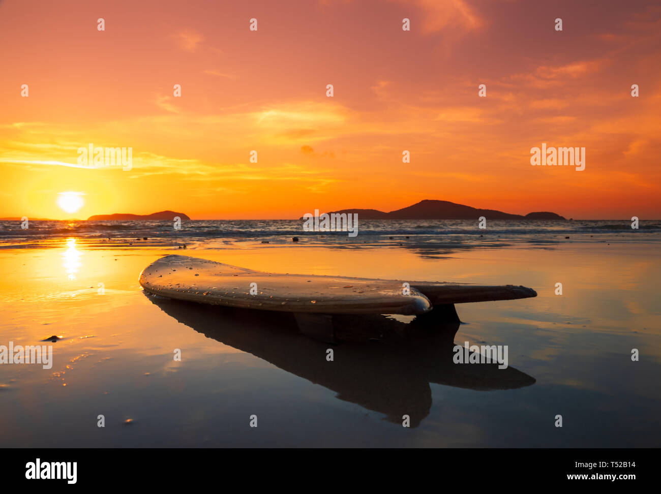 surfboard on the beach in sea shore at sunset time with beautiful light ...