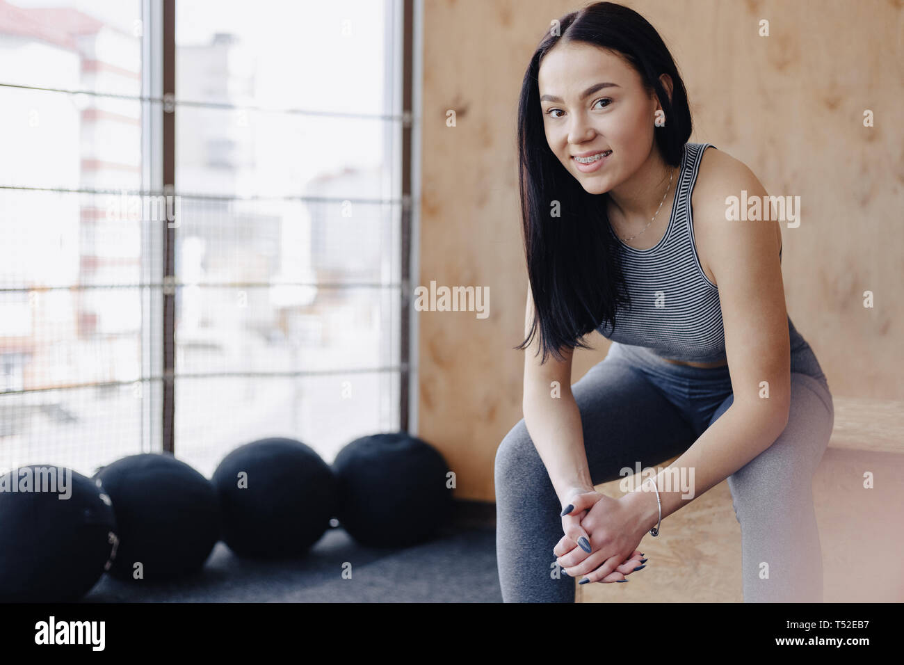 young girl in sportswear in a gym in a simple background, a theme of ...