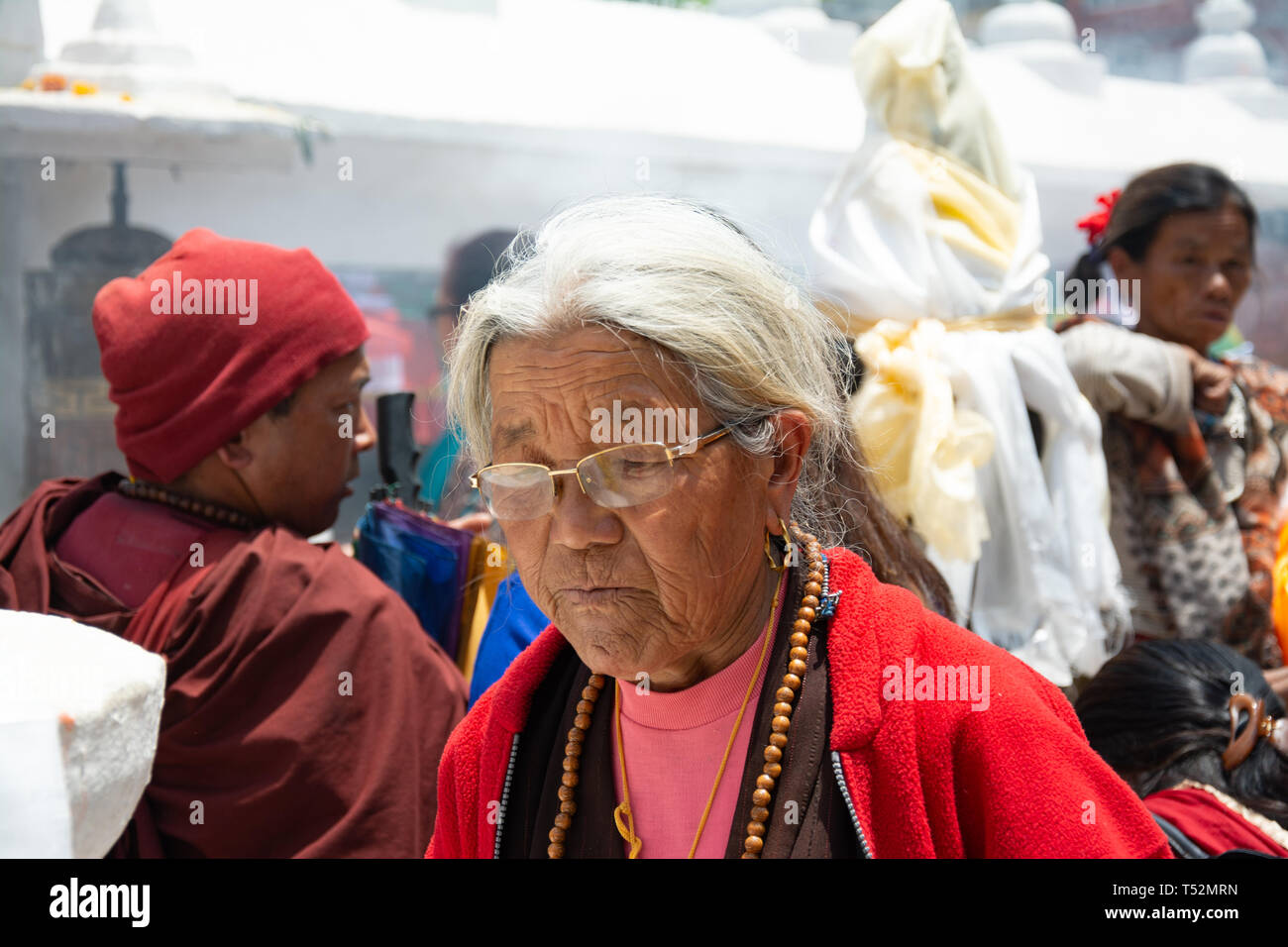 Kathmandu, Nepal - May 10, 2017: An old female buddhist devotee ...