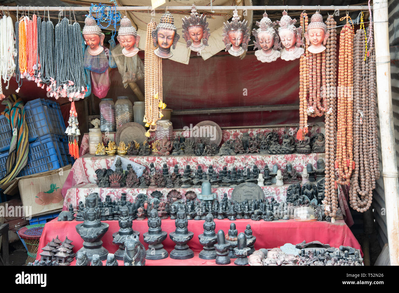 Display of small stone carved idols of Hindu gods and rosaries of ...