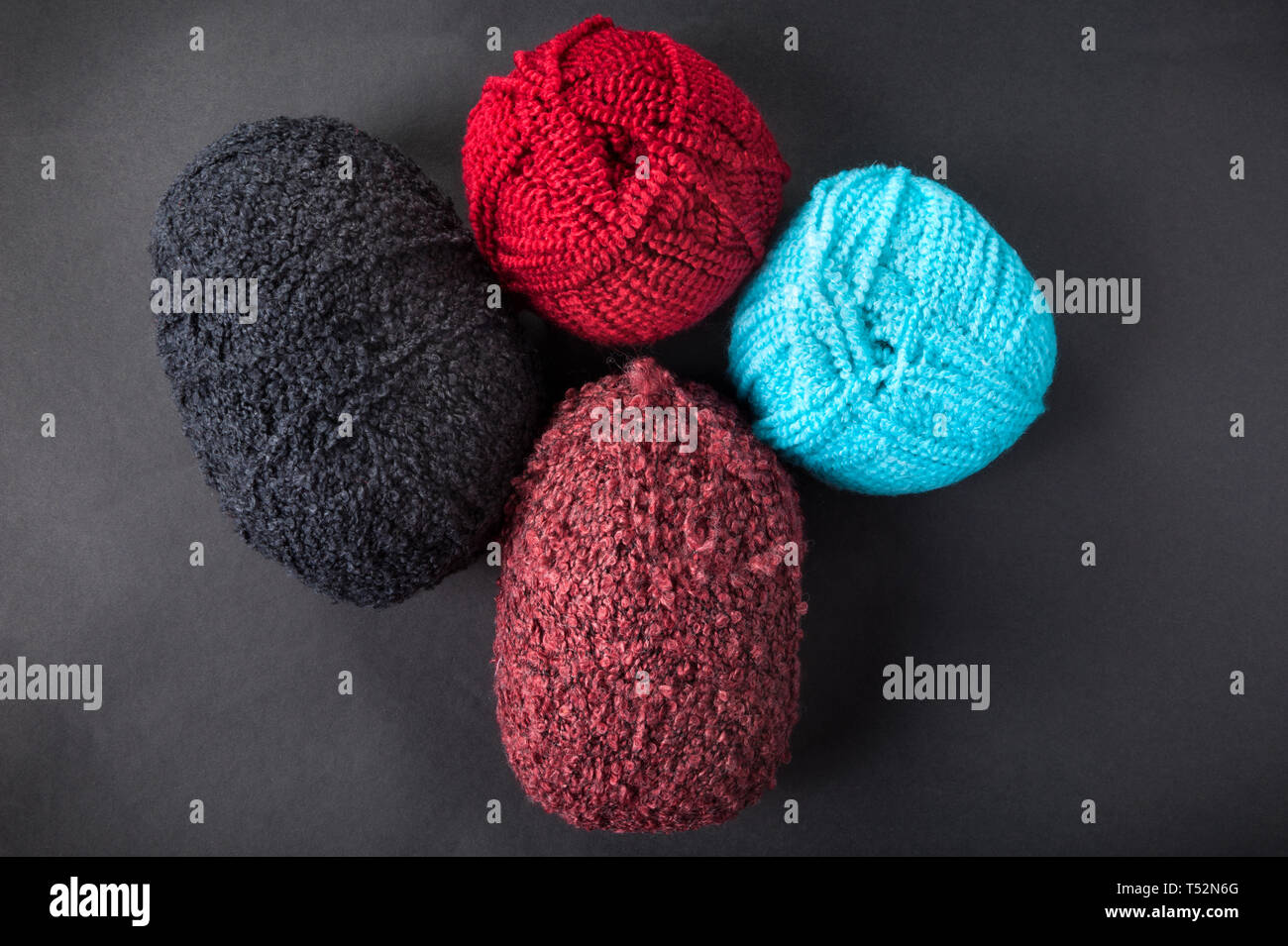 different color wool balls on dark background Stock Photo - Alamy