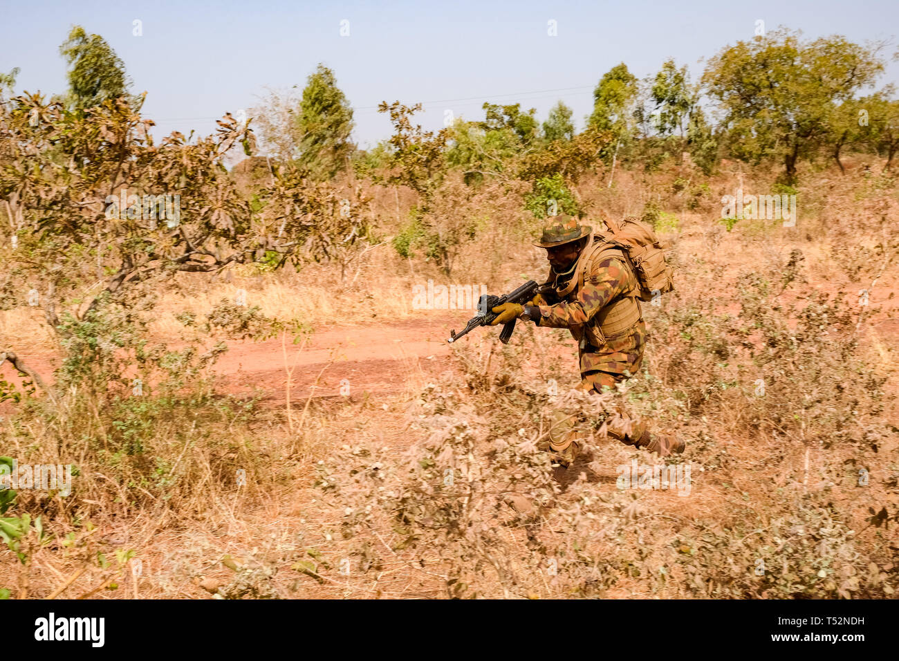 A Nigerian Army Soldier Runs Through The Bush During Counter Terrorism