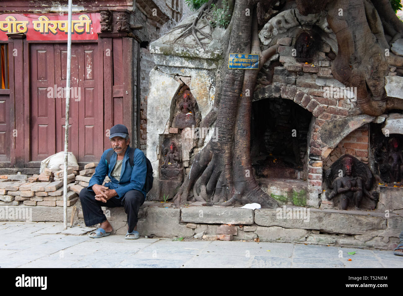 Kathmandu, Nepal - June 02, 2017: Unknown man sitting aside to a small ...