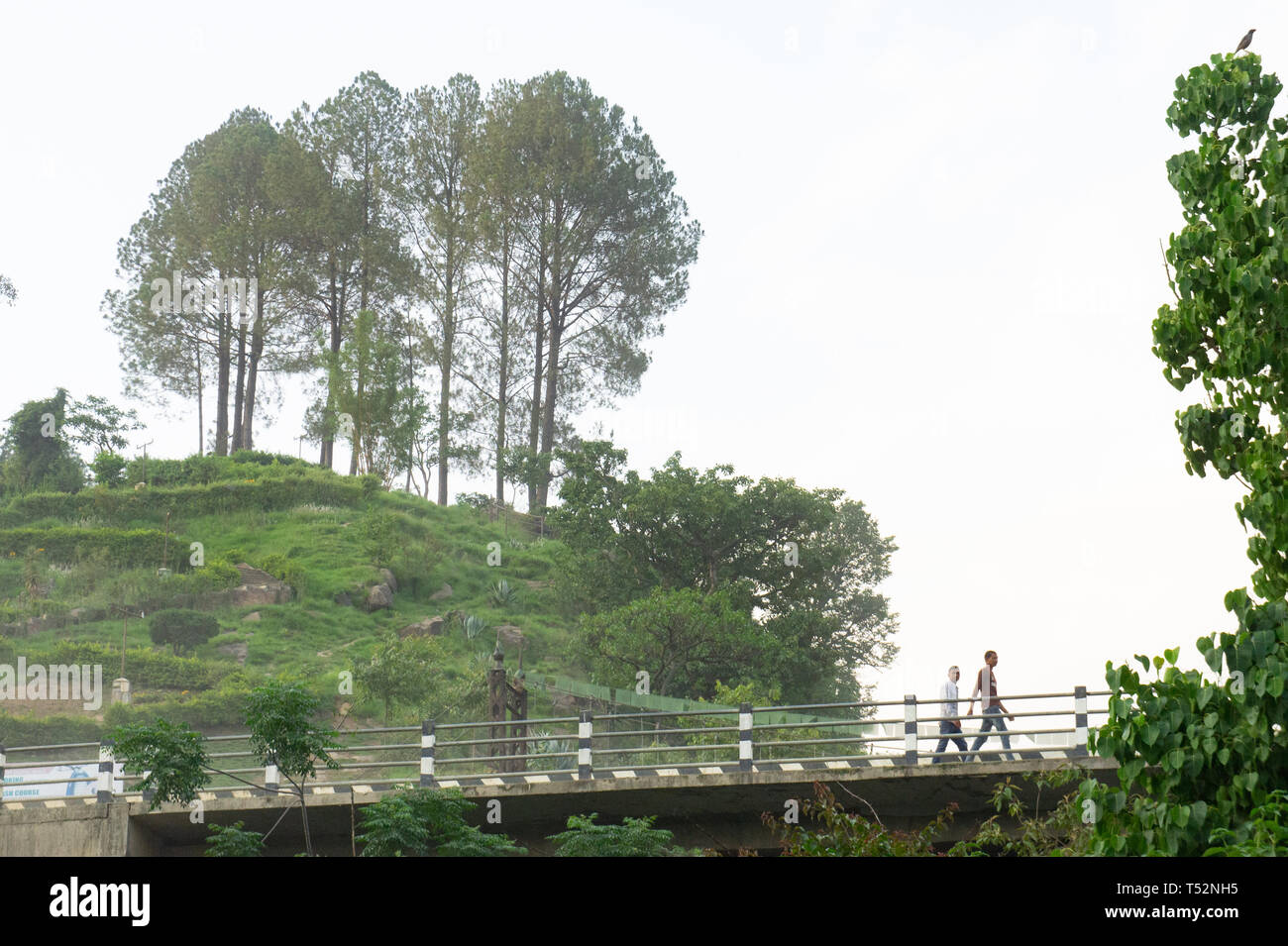 Kathmandu, Nepal - June 03, 2017: Unknown men walking over the bridge ...
